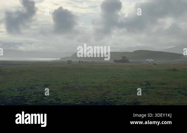 Expansive Green Meadow under Dramatic Cloudy Sky in Iceland. High ...