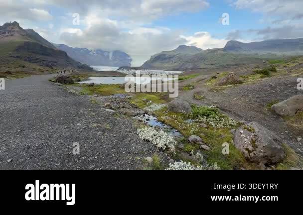 Winding Gravel Path Through Barren Plain with Snowy Mountains in ...