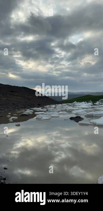 Reflection of Dramatic Clouds in Calm Glacier Lagoon Water in Iceland ...