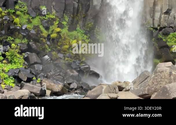 Majestic Waterfall Cascading Down Basalt Cliff with Green Vegetation in ...