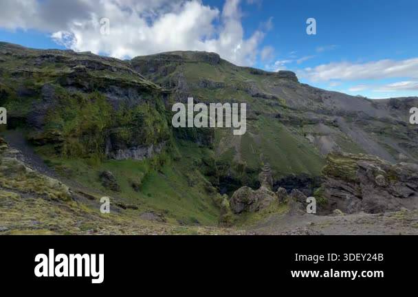 Green Hills and Distant Waterfall in Mulagljufur Canyon Iceland. High ...