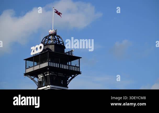 Iconic zoo observation tower flying the flag of Denmark on a clear day ...