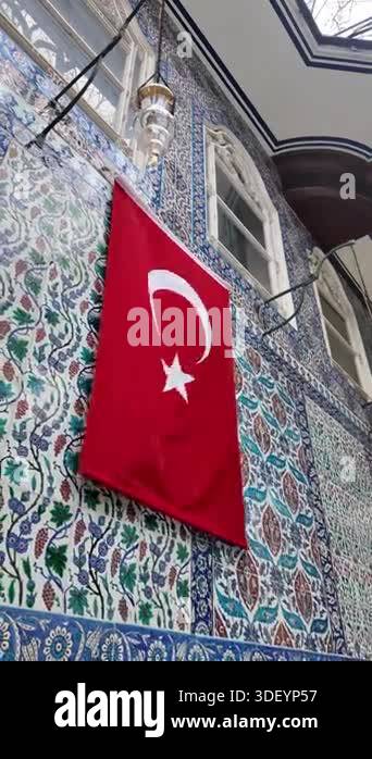A flag hangs on a wall in a historic place in Turkey with decorative ...