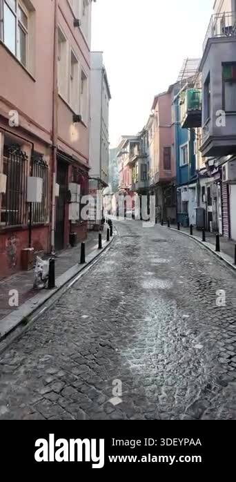 Stroll along a narrow street lined with colorful buildings in daylight ...