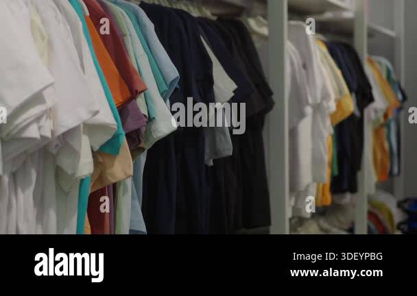 Sorting and arranging shirts in a closet for better storage Stock Video ...