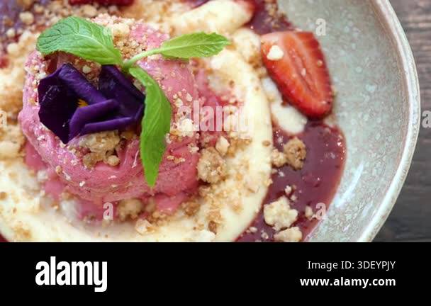 A person is tasting a sweet treat with ice cream and fruit today Stock ...