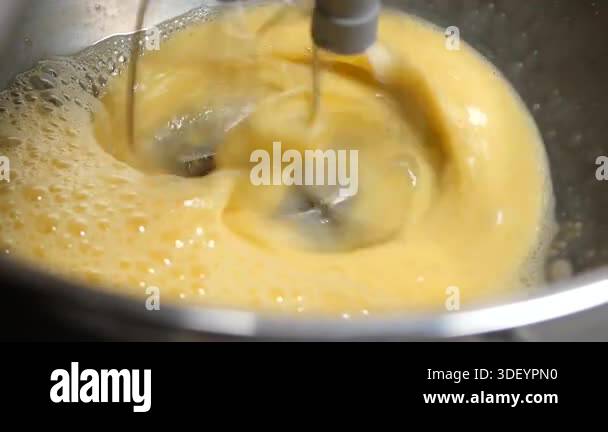 Eggs being mixed for a cooking project in a kitchen Stock Video Footage ...