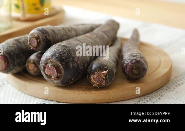 Fresh black radishes are arranged on a wooden cutting board Stock Video ...