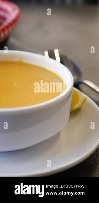 Hot soup served with a slice of lemon on a plate Stock Video Footage ...
