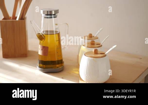 Oil and spice containers are arranged on a wooden table Stock Video ...