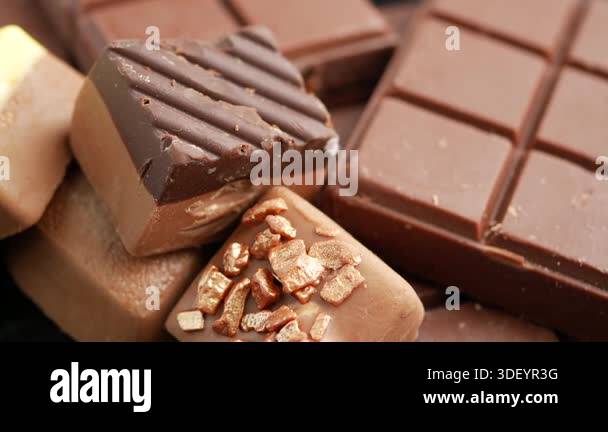 People are placing different types of chocolate on a table Stock Video ...