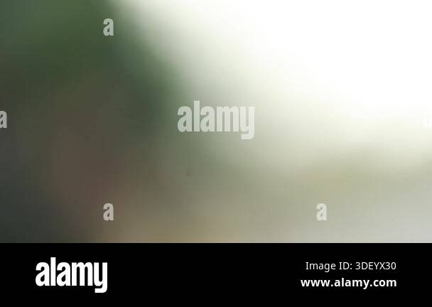 Abstract video footage featuring a bright white blurred highlight ...