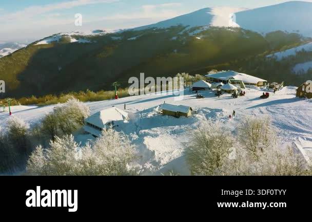 An old ski station on a steep snow-covered mountain slope covered with ...