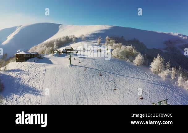 An old ski station on a steep snow-covered mountain slope covered with ...
