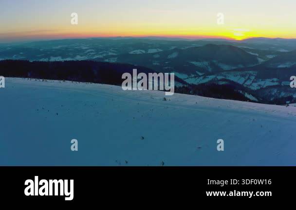 The extraordinary Carpathian valley with snow-capped hills and ...