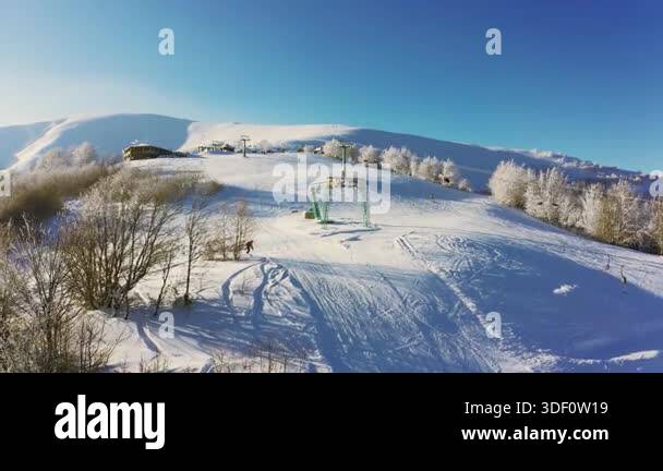 An old ski station on a steep snow-covered mountain slope covered with ...