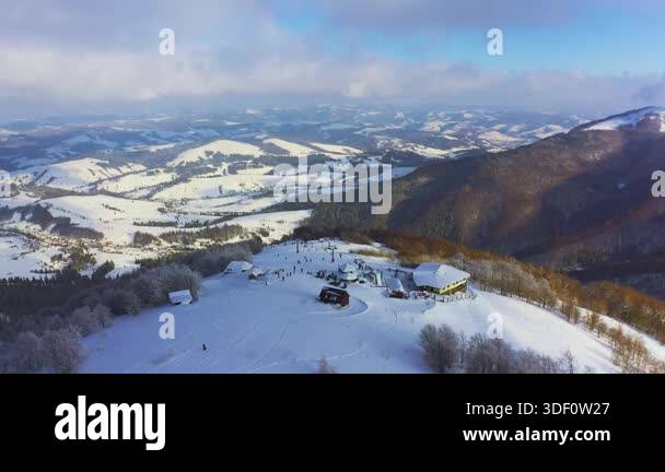 An old ski station on a steep snow-covered mountain slope covered with ...