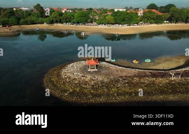 Aerial view of a traditional Balinese gazebo or Bale on the shore of ...