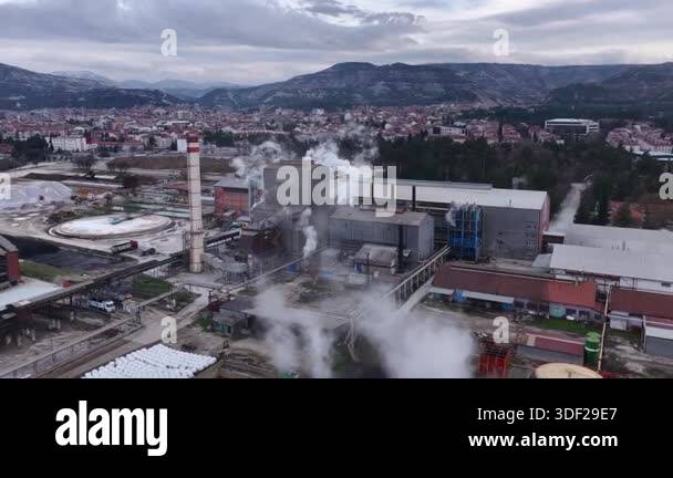 Aerial view of the sugar factory located in the city center; smoke ...