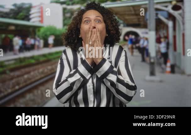 Woman opens mouth in astonished expression wearing striped shirt at ...