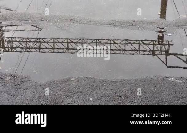 Reflection of electric tower in puddle after rain Stock Video Footage ...