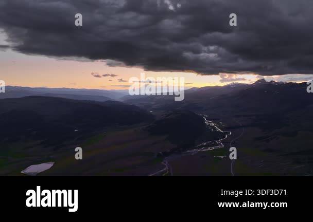 Aerial view. Twilight high above the ground at sunset in the mountains ...
