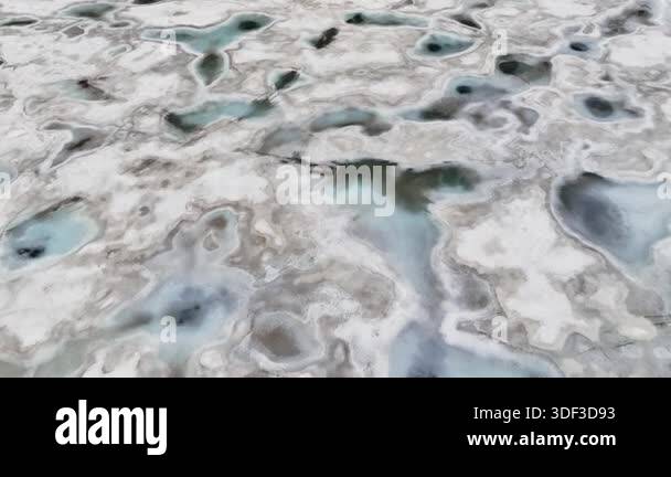 Top view of floating ice with snow in a mountain lake, panoramic ...