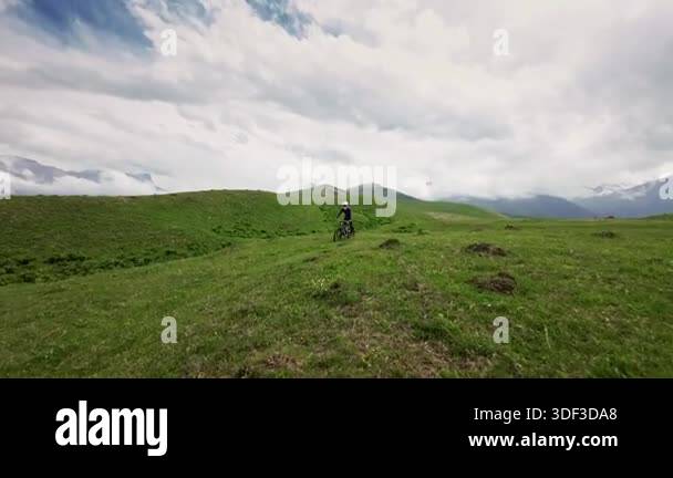 Aerial view fpv drone professional rider sport mountain bike follow ...