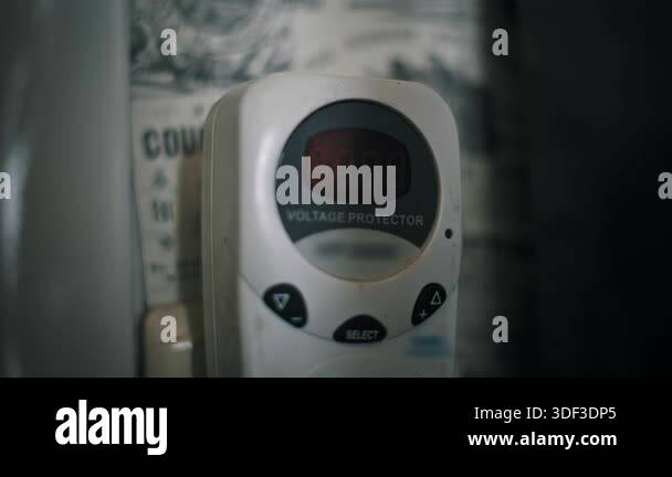 Macro shot of a voltage protector red digital display showing an unsafe ...