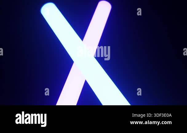 Pink and blue neon light sabers cross each other against a dark ...