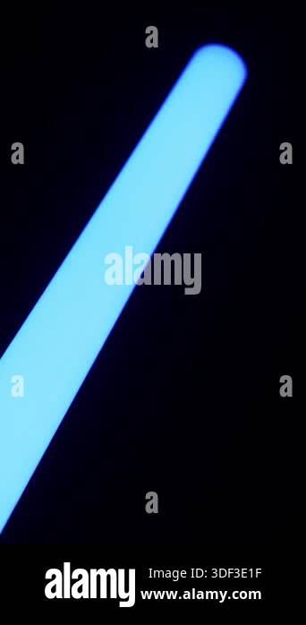 Blue and red neon light swords cross and duel against a solid black ...