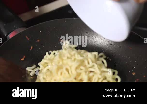 Frying Instant Noodles with Wooden Spatula in Pan Stock Video Footage ...