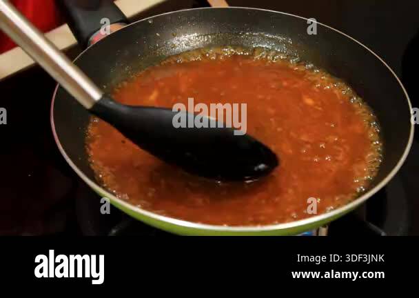 someone is cooking chili sauce Stock Video Footage - Alamy
