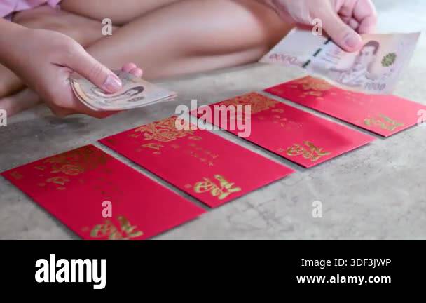 Giving Red Envelopes angpao with Thai Banknotes for Lunar New Year ...
