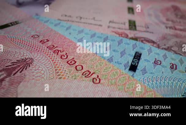 The close-up shows various banknotes featuring different designs and ...
