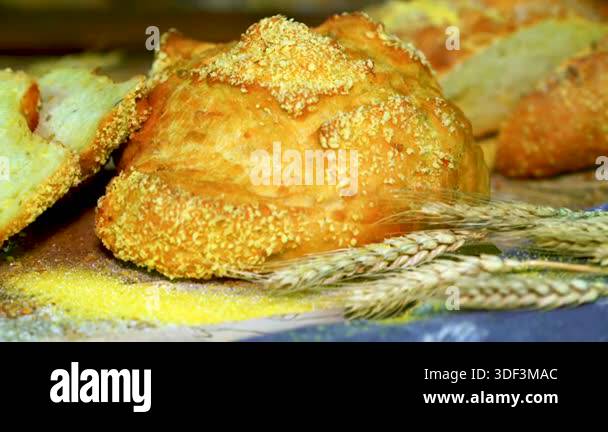 A baker prepares to make bread using flour and grains in a cozy kitchen ...