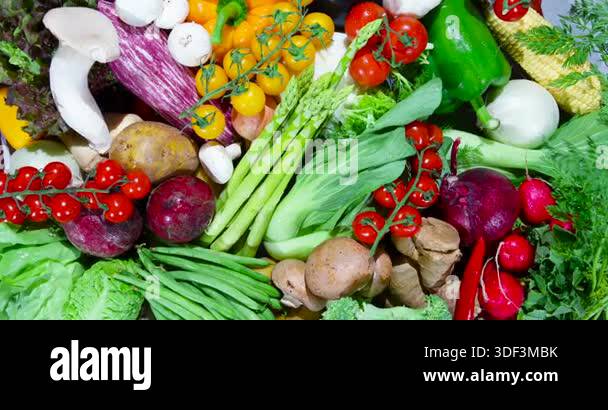 A collection of fresh vegetables is shown, including tomatoes ...