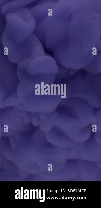 Slow motion video of violet ink cloud dispersing in water. Abstract ...