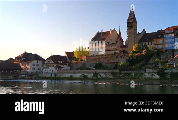 A historic town sits along the river, featuring a castle and charming ...