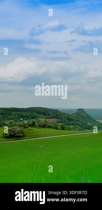 Green Rolling Hills Under Blue Sky, Meandering Country Lane And Distant ...