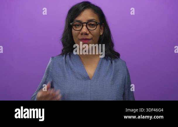 Woman blowing kiss with hand to lips wearing glasses and blue blouse in ...