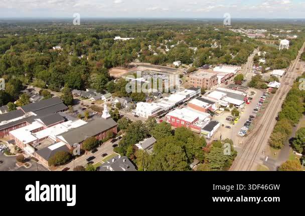 Aerial drone footage tracking over a lush green residential area in ...