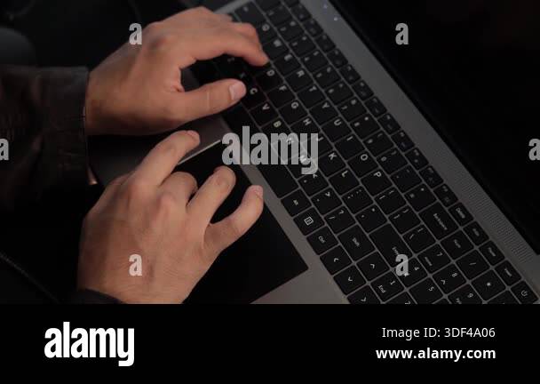 Businessman working on a laptop at his desk, representing focus ...
