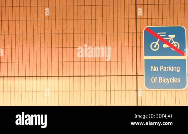 No parking for bicycles sign on tiled wall in urban city showing bike ...