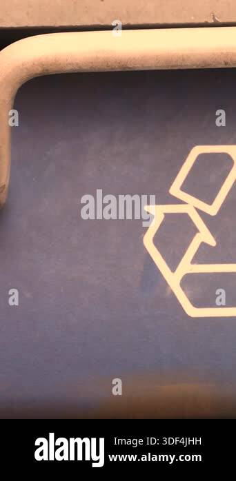 Recycling symbol on metal handled waste bin representing eco friendly ...