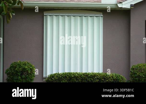 Steel sheets mounted as storm shutters for hurricane protection of ...
