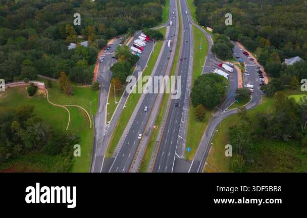 Highway rest area with parking spaces for cars and trucks along busy ...