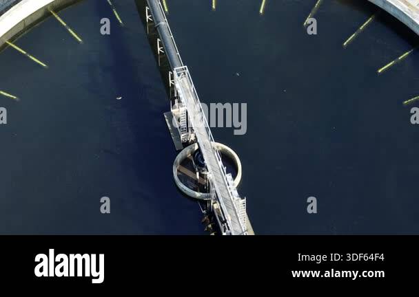 Large water treatment facility tank with a central rotating arm. The ...
