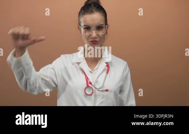 Hispanic young woman wearing a lab coat and stethoscope gives ...