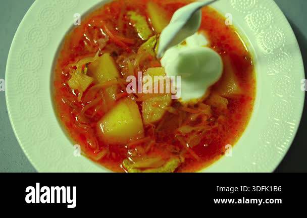 Borsch. Put sour cream. Cooking traditional national Russian, Ukranian ...